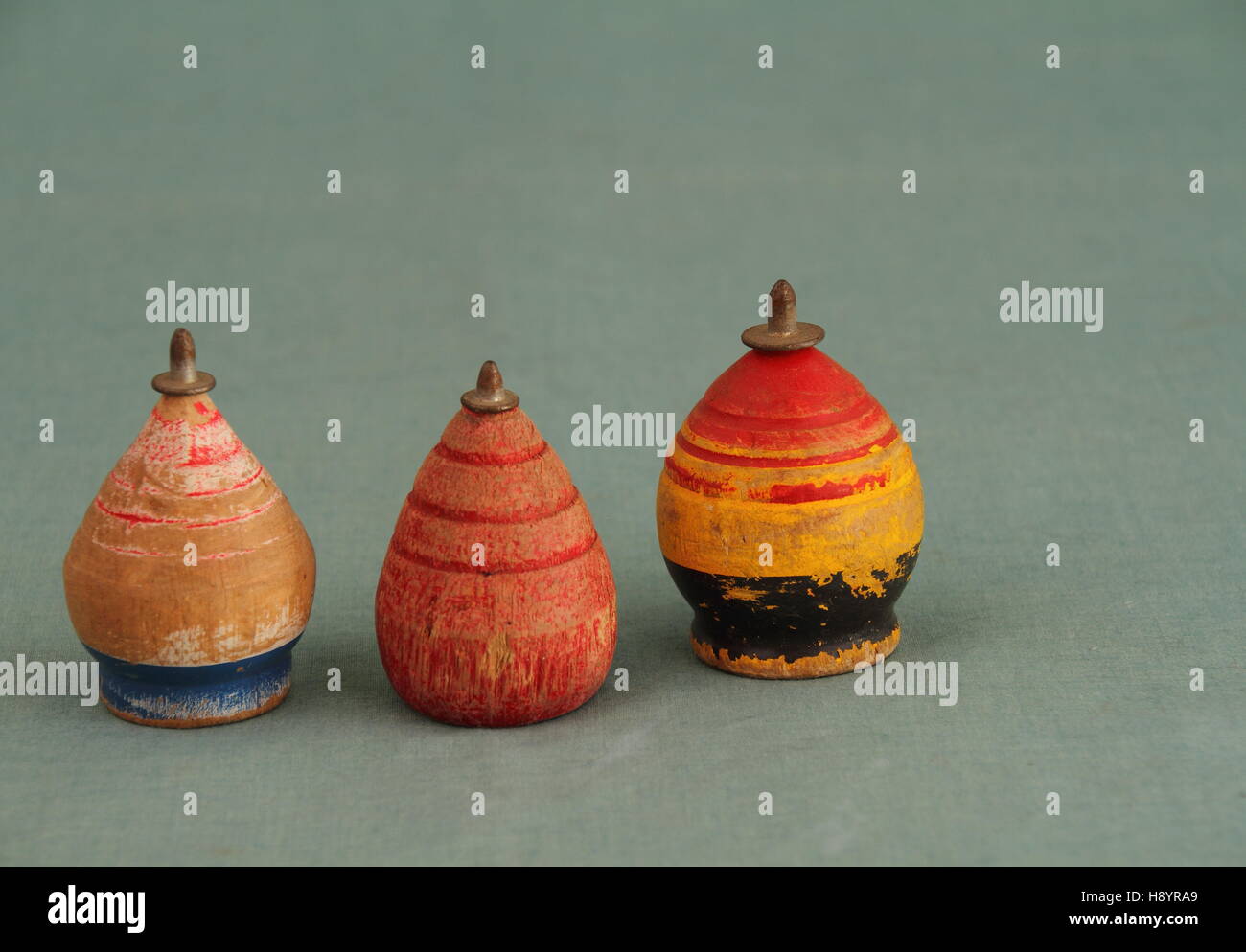 Vintage spinning tops toys carved from wood isolated image with copy ...