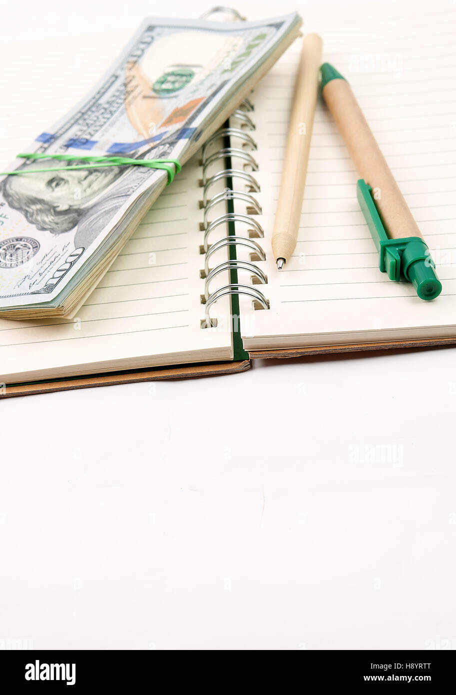 pen and money isolated on white background Stock Photo - Alamy