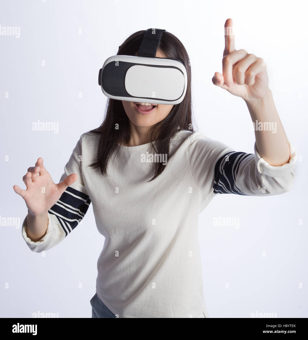 asian woman wearing VR headset, moving her body happily, isolated white ...