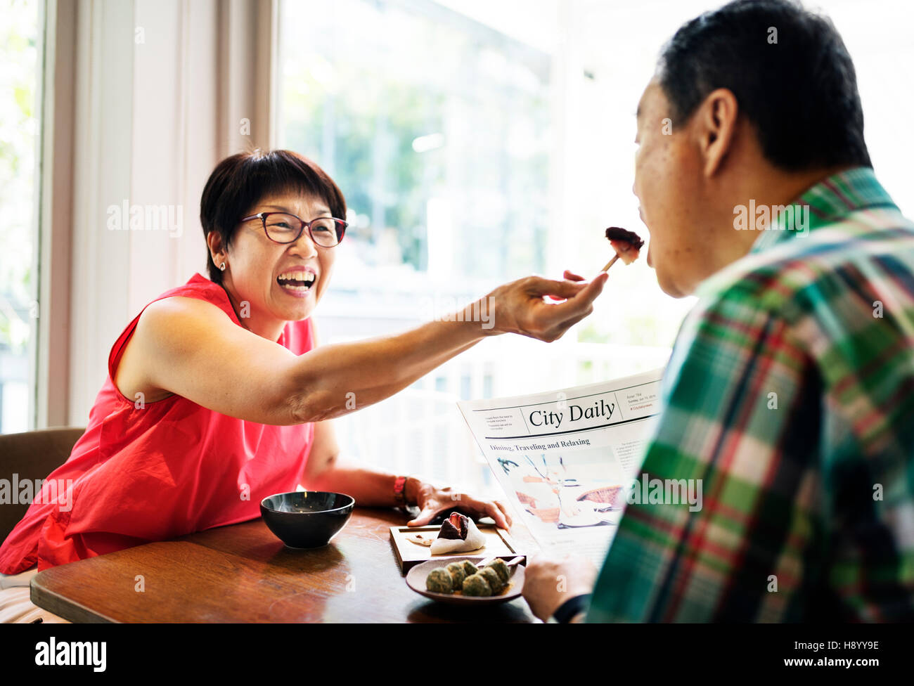 Elderly Senior Couple Playful Feeding Cafe Concept Stock Photo - Alamy