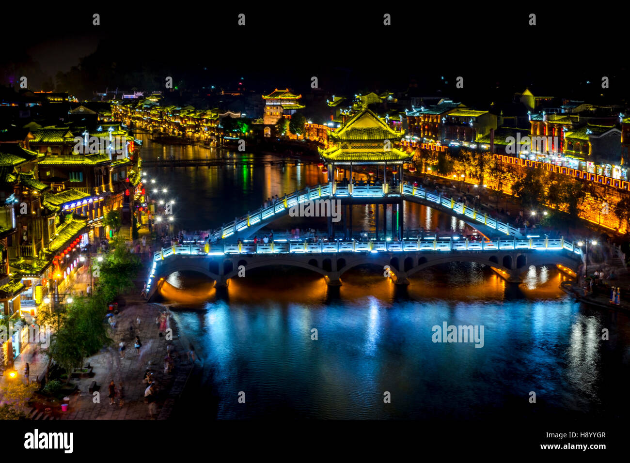 Illuminated Fenghuang bridge over Tuojiang river in downtown Fenghuang ...