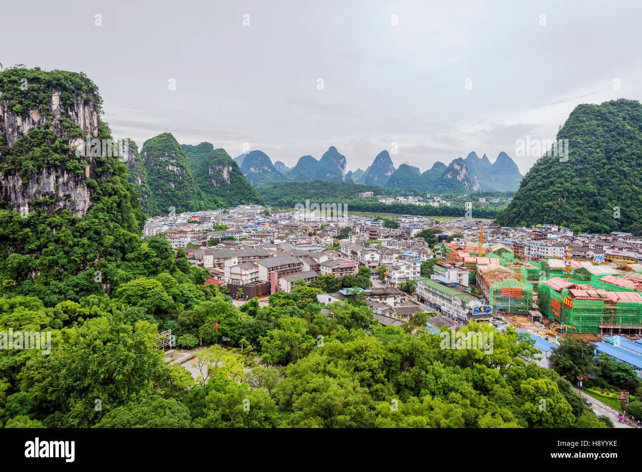 YANGSHUO, CHINA - JUNE 12: View over skyline of Yangshuo surrounded ...