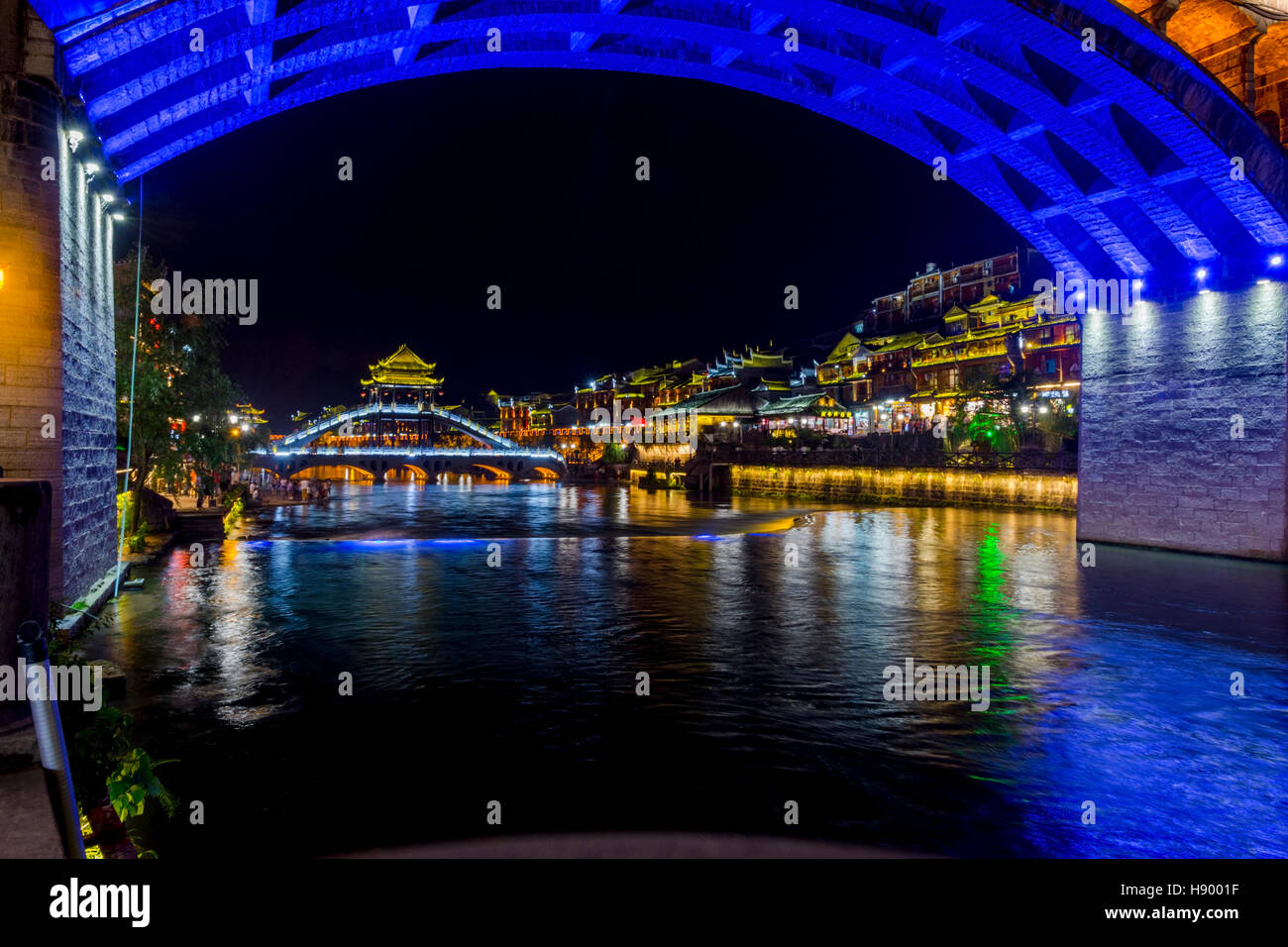 Illuminated Fenghuang bridge over Tuojiang river in downtown Fenghuang ...