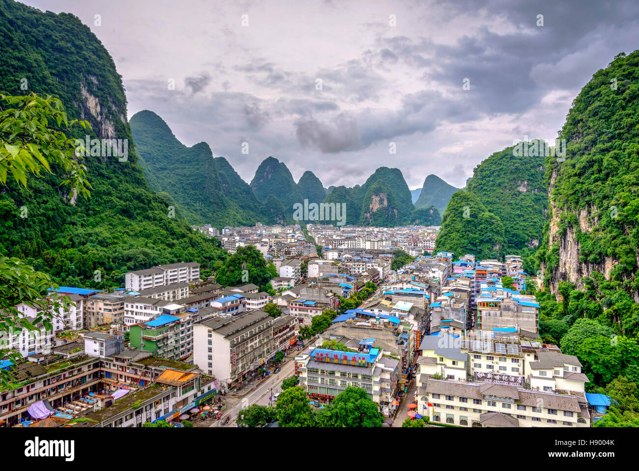 YANGSHUO, CHINA - JUNE 12: View over skyline of Yangshuo surrounded ...