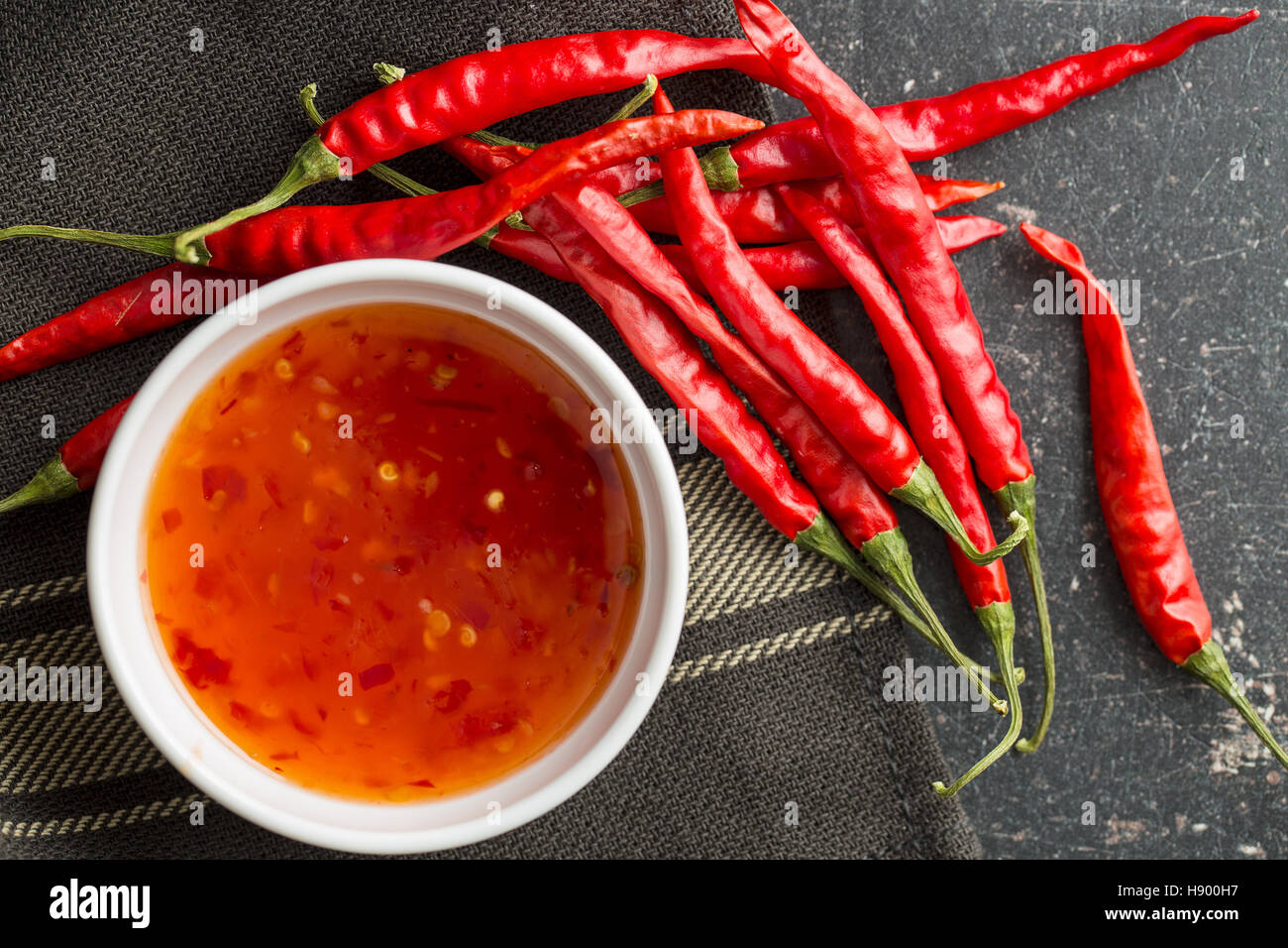 Red chili peppers and chili sauce. Top view Stock Photo - Alamy