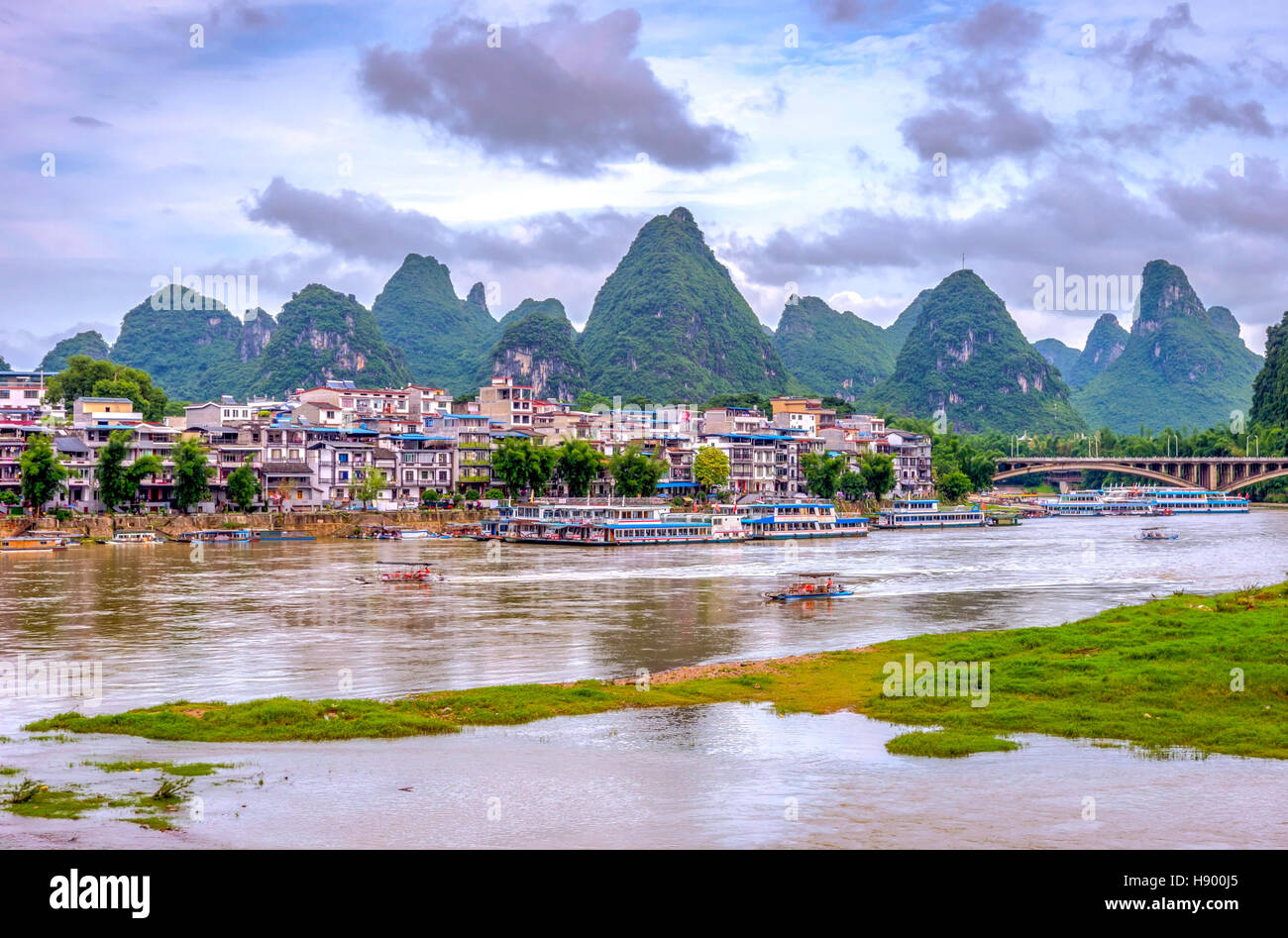 YANGSHUO, CHINA - JUNE 12: View over skyline of Yangshuo surrounded ...