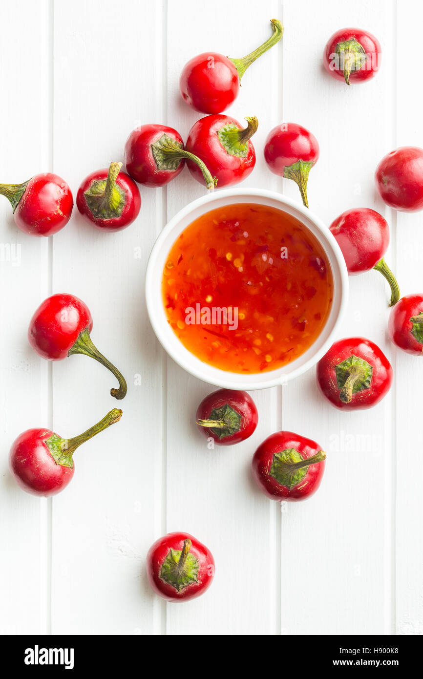 Red chili peppers and chili sauce. Top view Stock Photo - Alamy