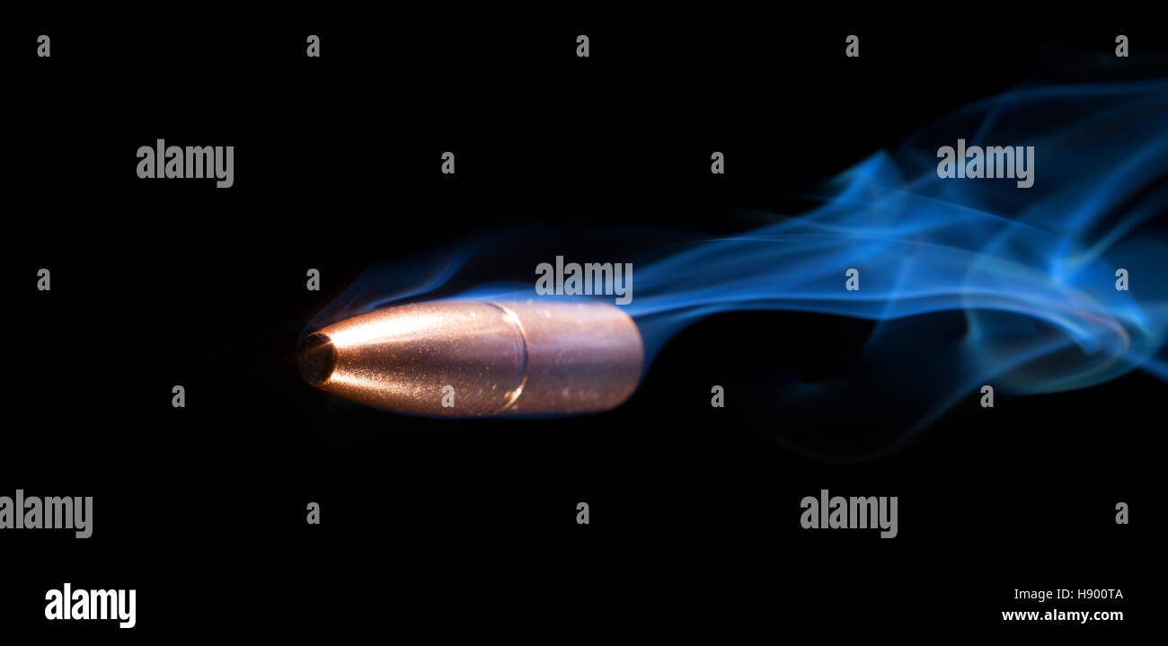 Smoking bullet flying from right to left by the camera Stock Photo - Alamy