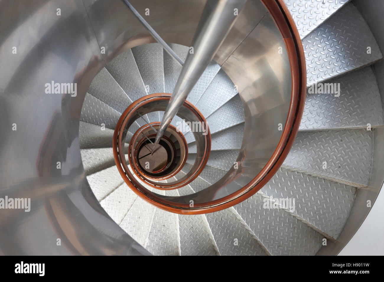 Metallic spiral stair with wooden handrails inside a lighthouse ...