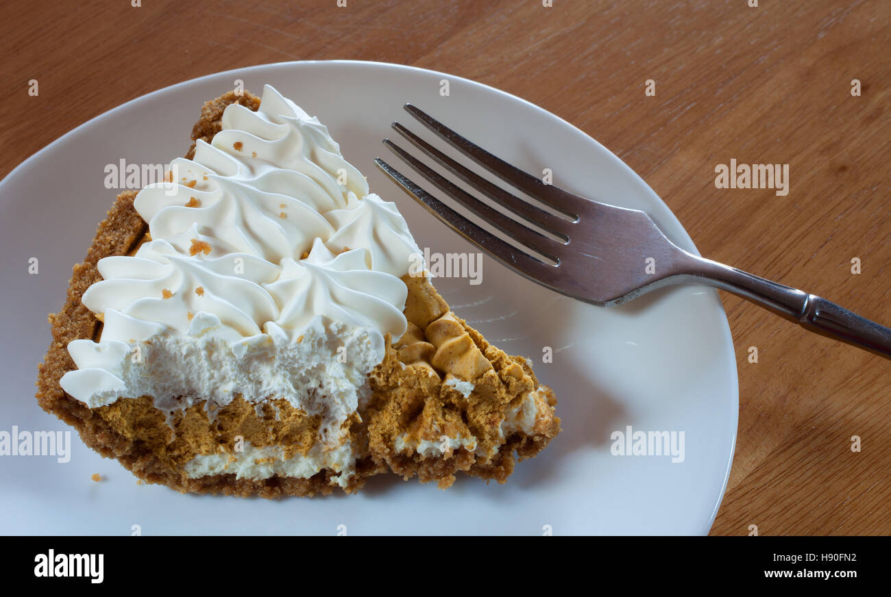 Fork ready to dive into a piece of whipped pumpkin pie Stock Photo - Alamy