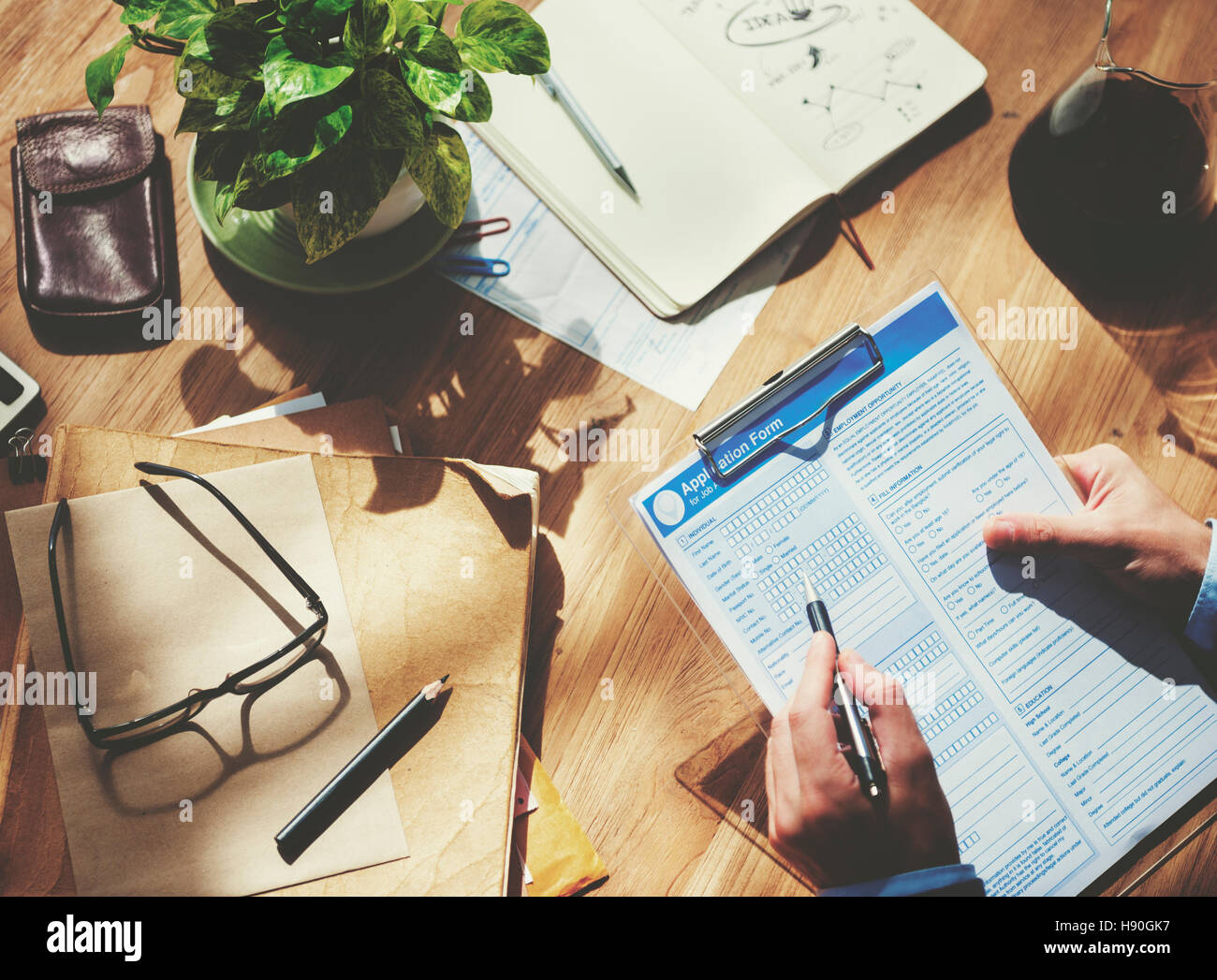 Businessman Filling Up Form on Office Desk Concept Stock Photo - Alamy