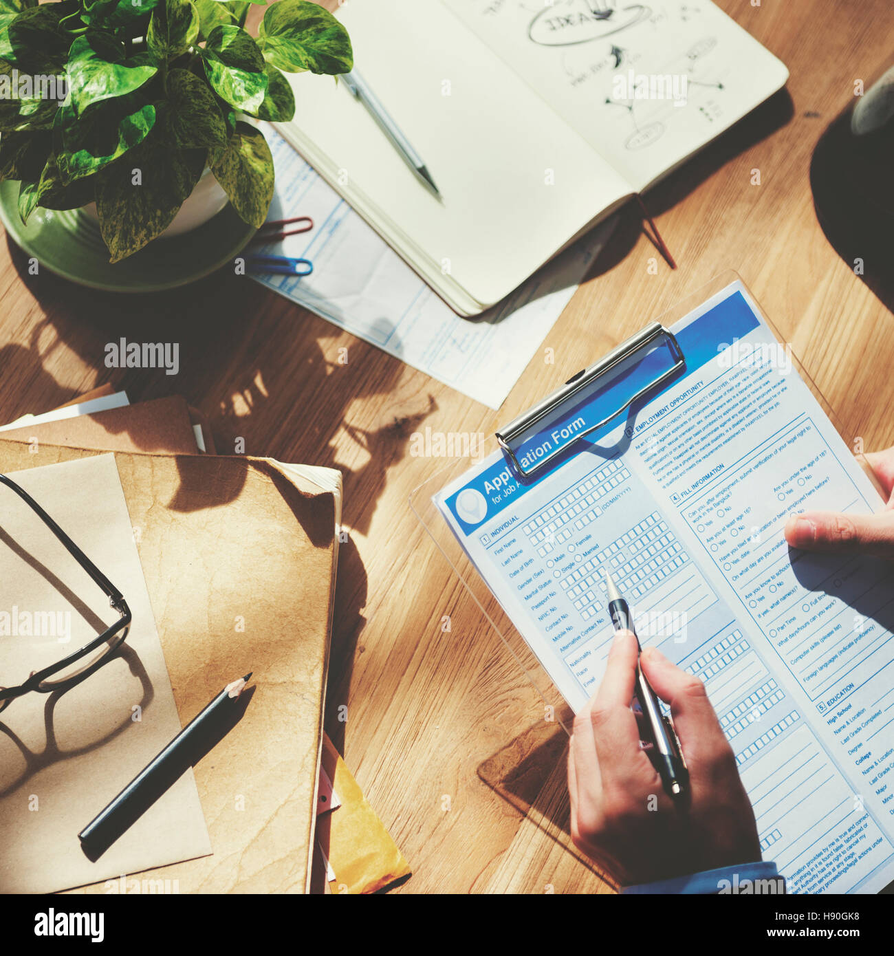 Businessman Filling Up Form on Office Desk Concept Stock Photo - Alamy