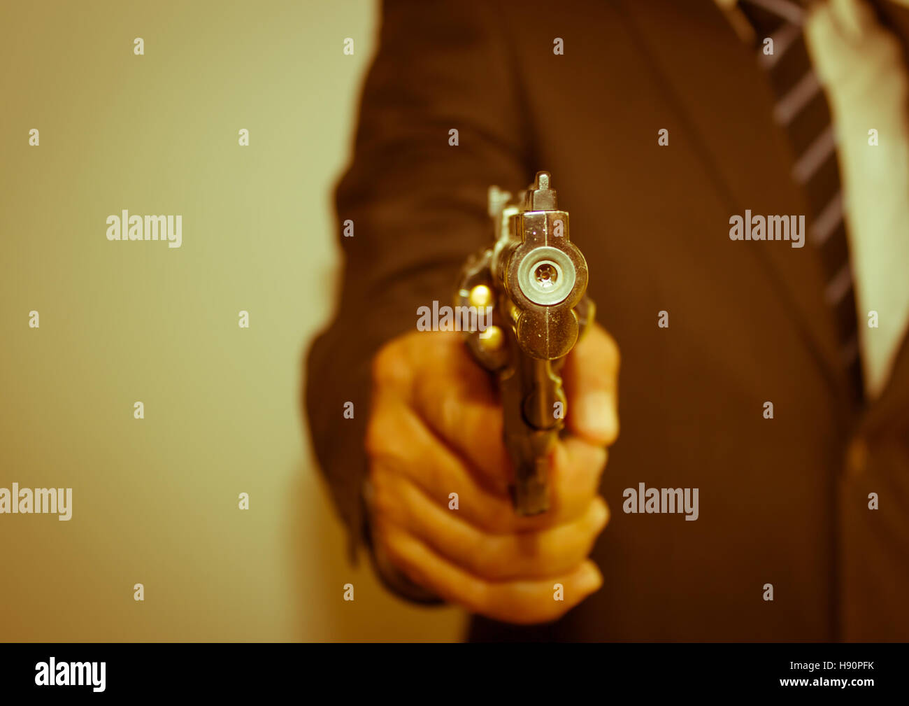 Businessman with gun Stock Photo - Alamy