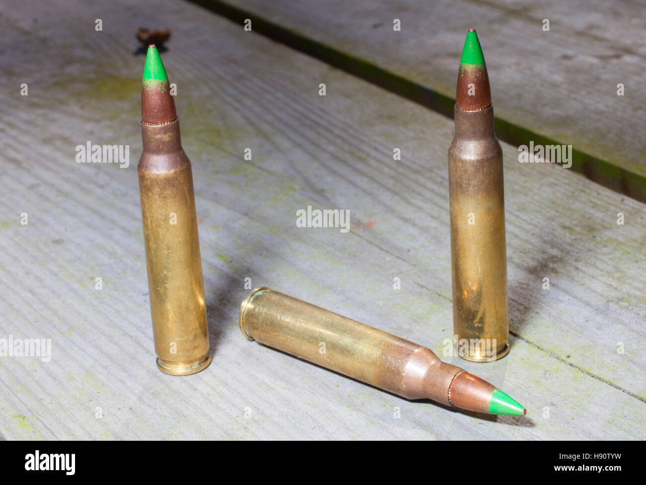 Cartridges that are loaded with bullets with a green tip Stock Photo ...