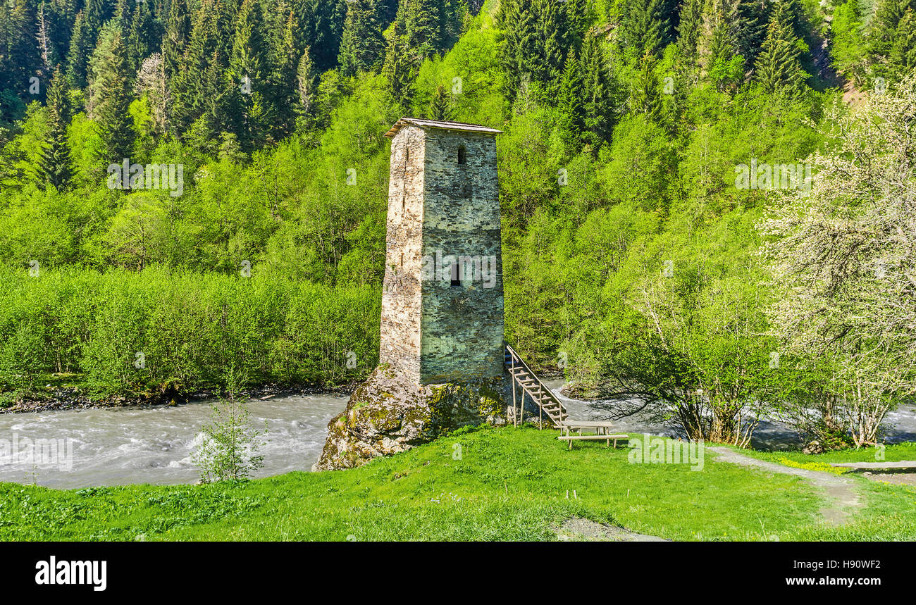 The medieval Svan Love Tower on Enguri river, surrounded by lush forest ...