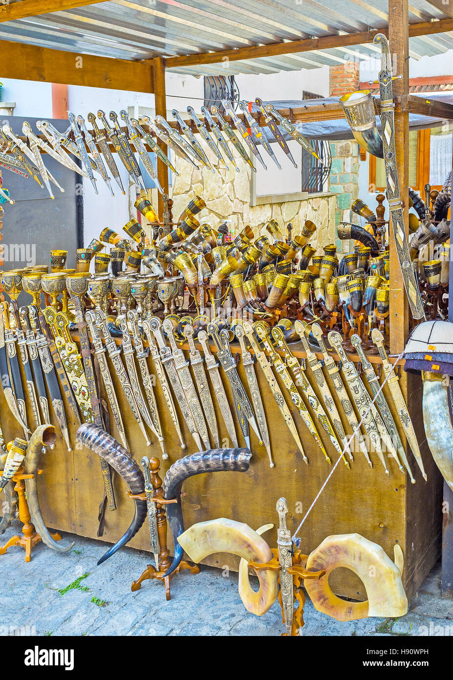 The market stall with the wide range of Caucasian cold weapon, drinking ...
