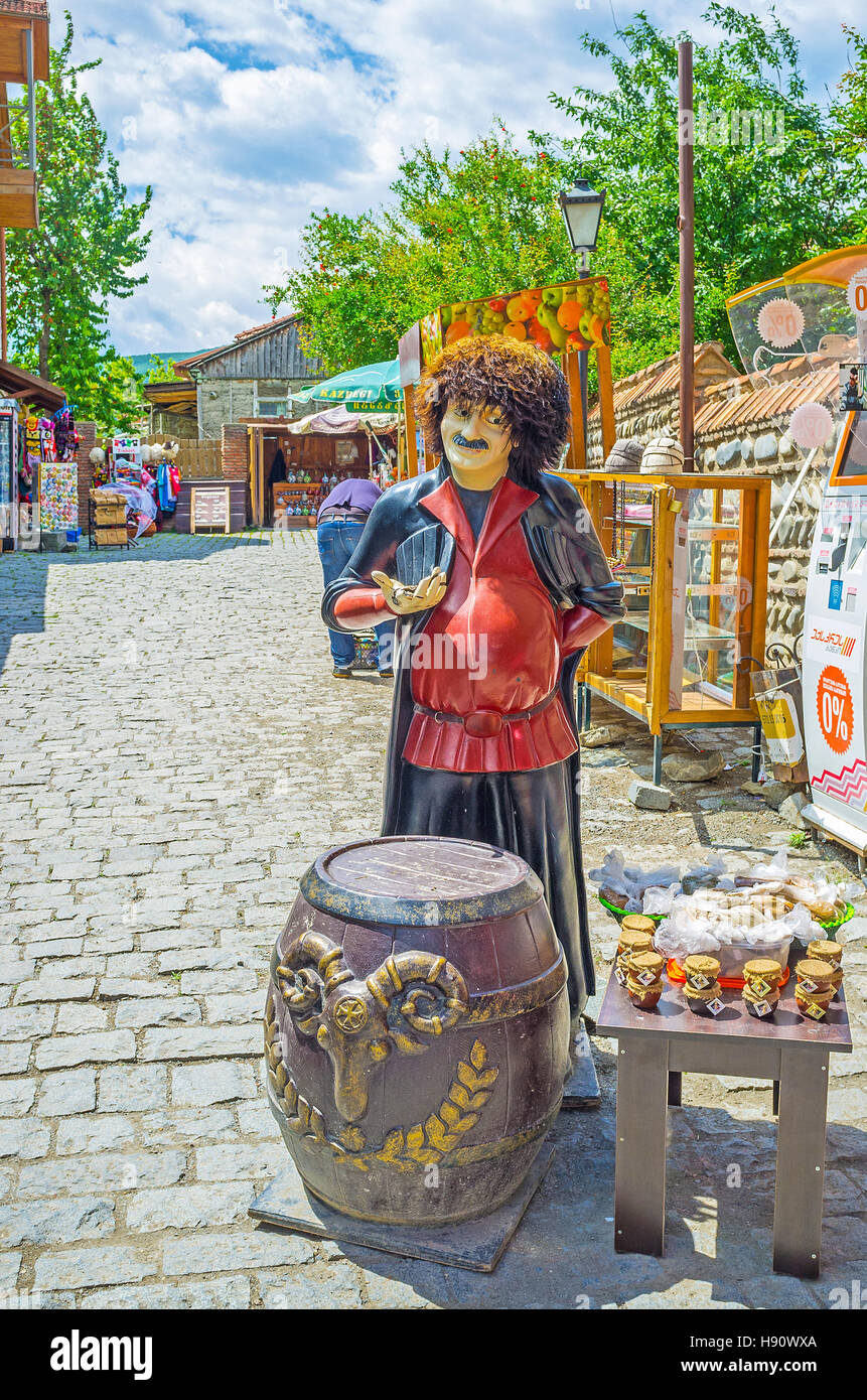 The wooden doll in national dress at the stall of local specialties ...
