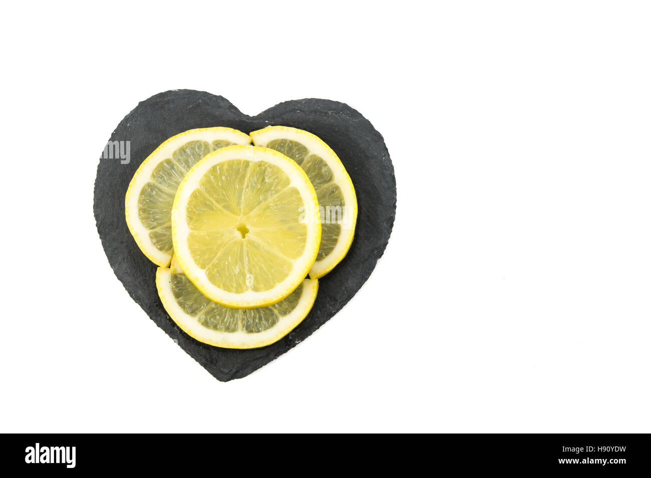 Lemon slices on heart shaped black slate Stock Photo - Alamy