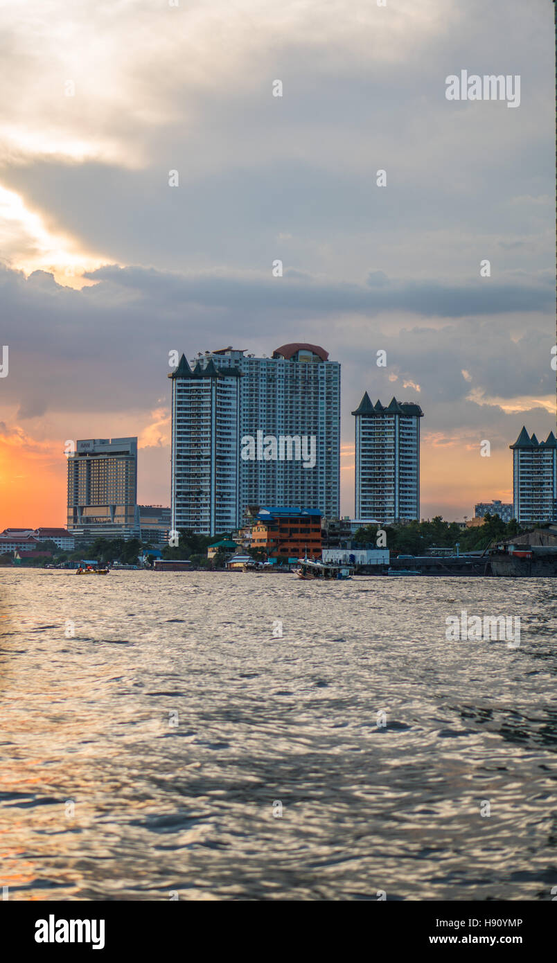 Boat view from Chao Praya river on Bangkok during beautiful sunset ...