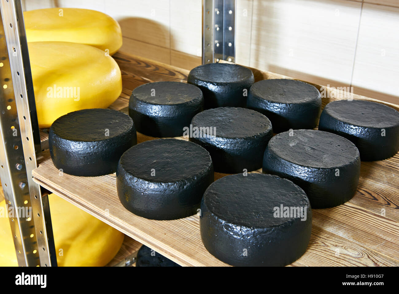Cheese factory warehouse with shelves stacked with cheese capretto and ...