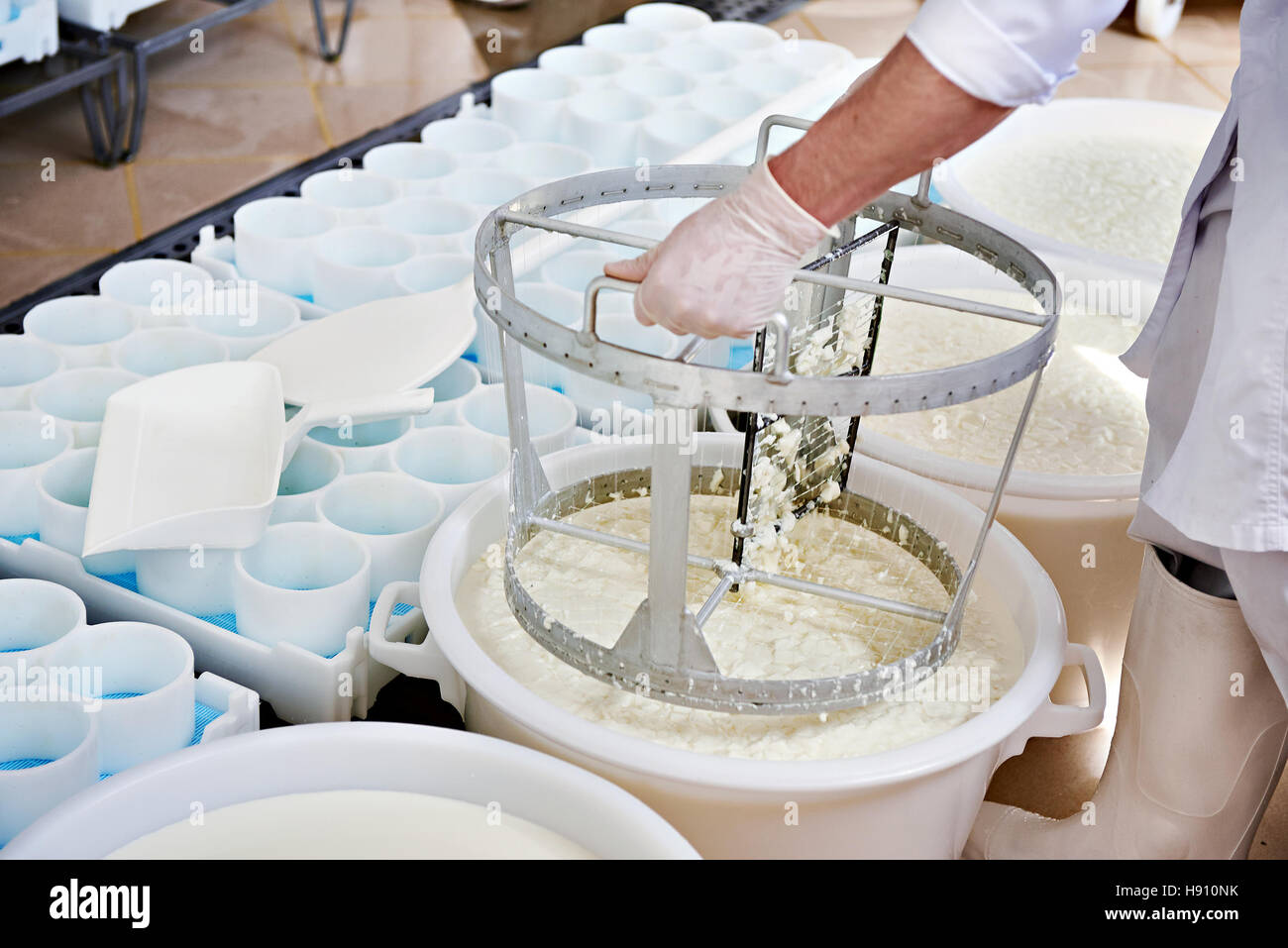 Mixing cheese material for the production of soft cheese Stock Photo ...