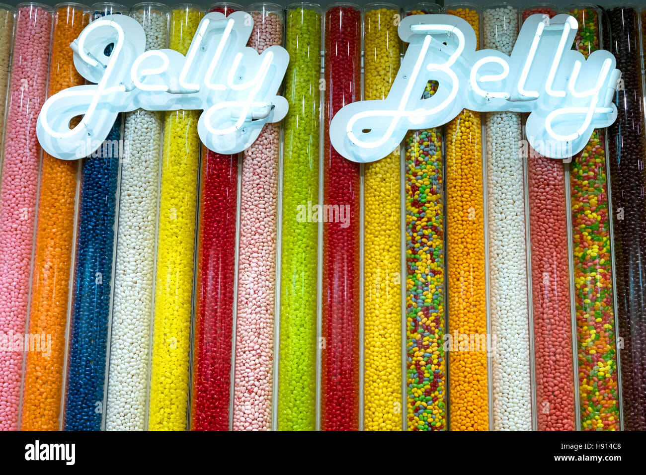 A display of multi-coloured varieties of jelly beans in clear vertical ...