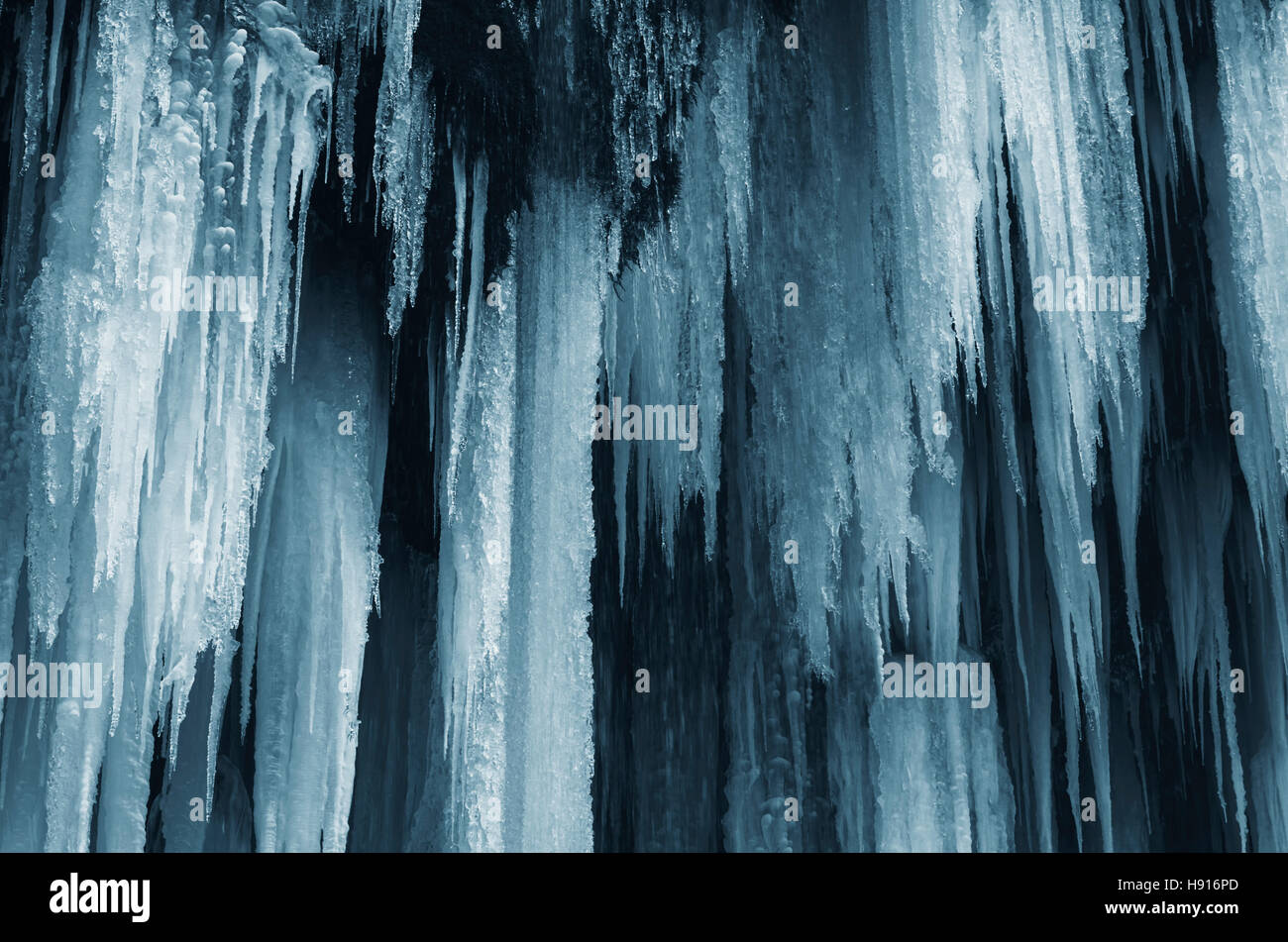 icicles hanging on frozen waterfall on cold winter day, natural ice ...