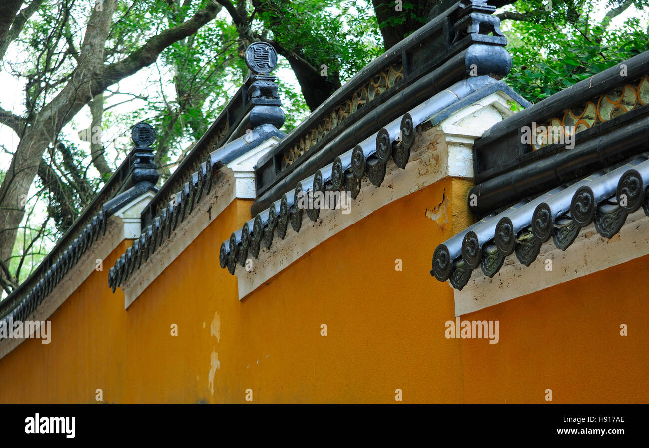 A weathered yellow wall leading up to the Fayu Temple complex on the ...