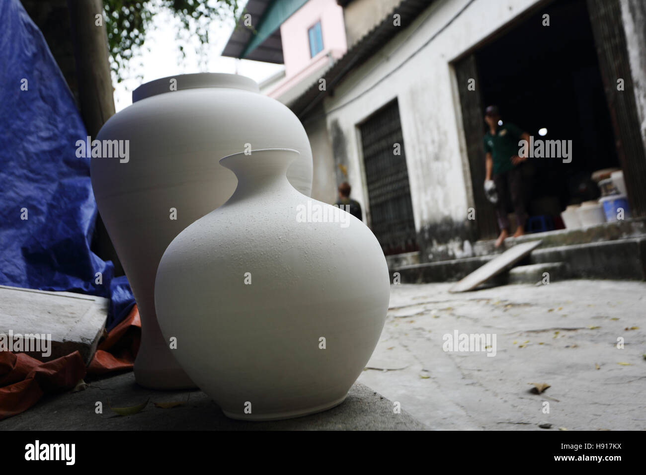Clay containers in front of a pottery workshop in Bat Trang Ceramic ...
