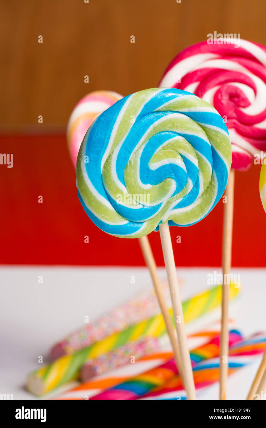 Multicolored sweet candy canes and twirls on wooden sticks, variety ...