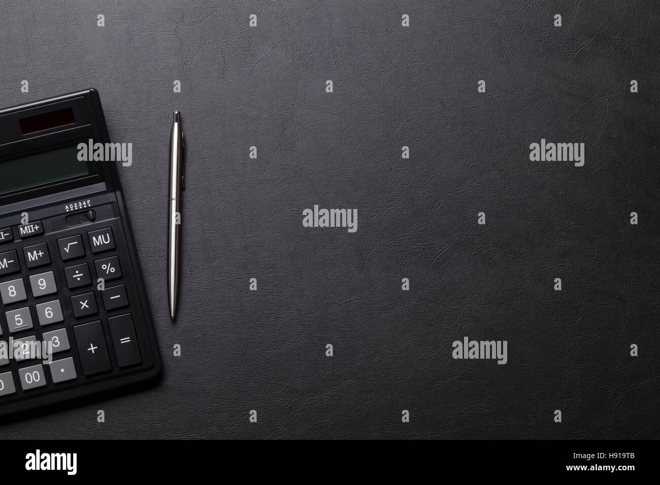 Office leather desk table with calculator and pen. Top view with copy ...