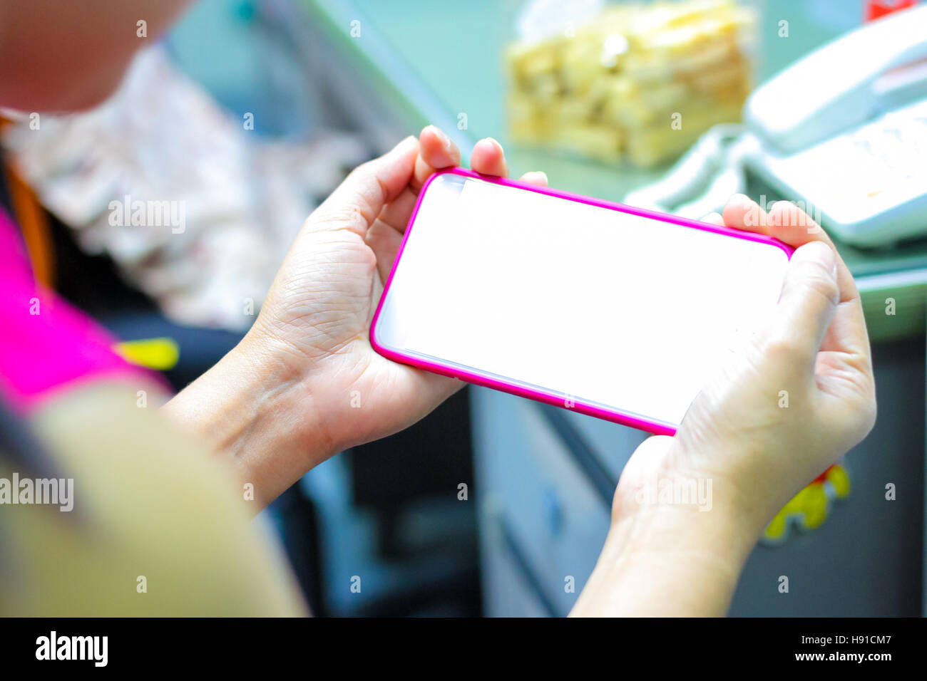 employees play mobile phone in the workplace Stock Photo - Alamy