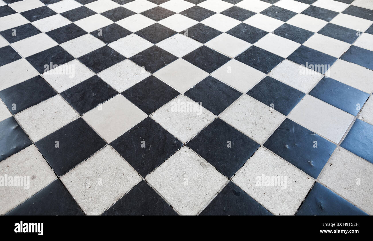 Retro stone floor tiling with black and white checkered pattern Stock ...