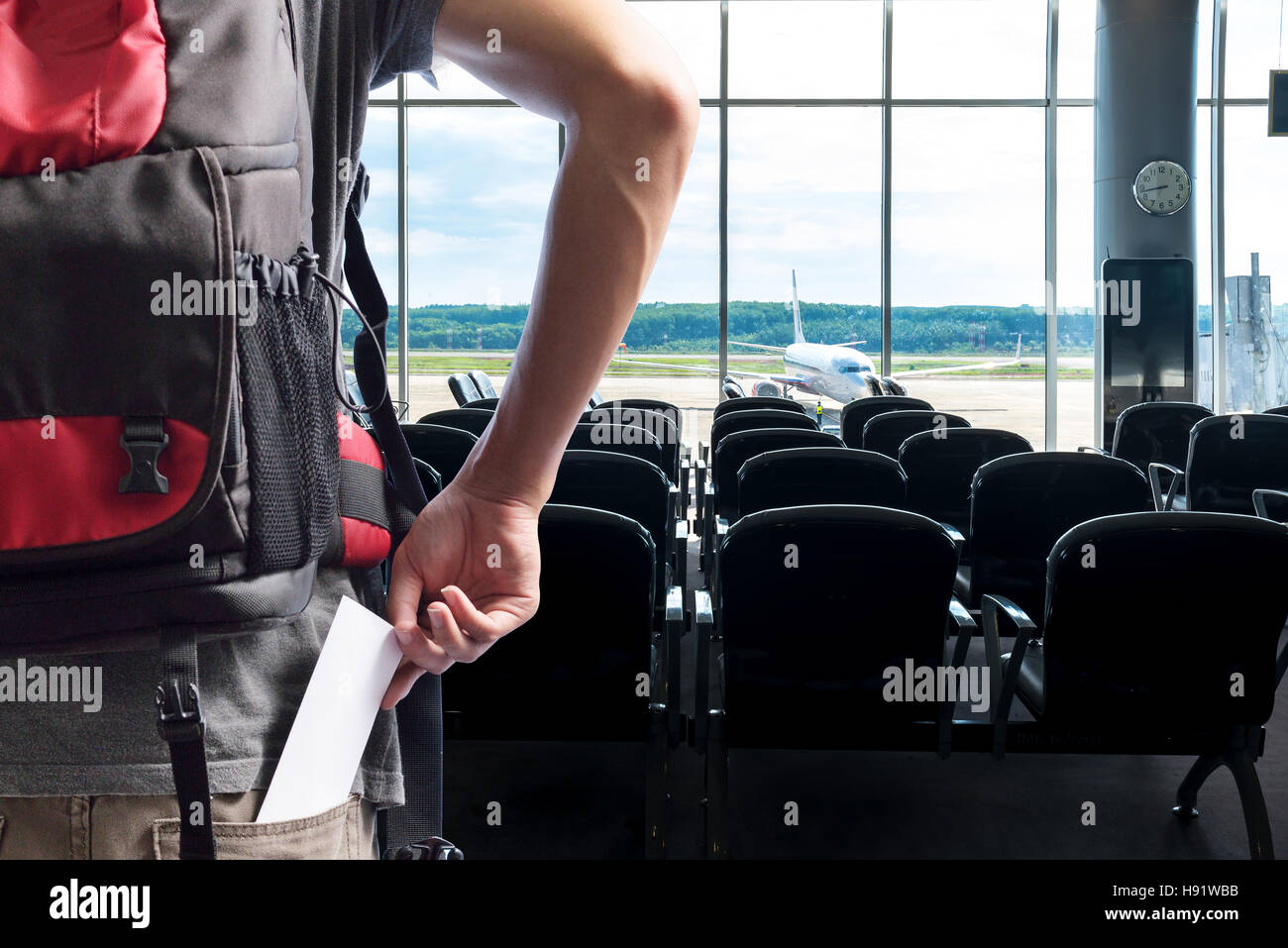 traveler presenting passenger tickets for flight at counter check-in ...
