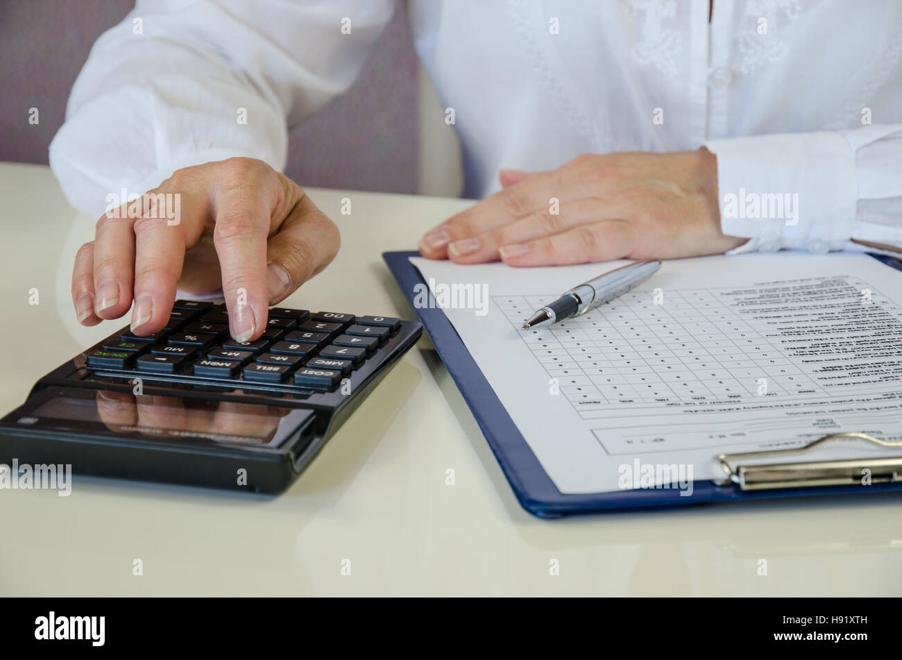 hand over calculation and paperwork Stock Photo - Alamy