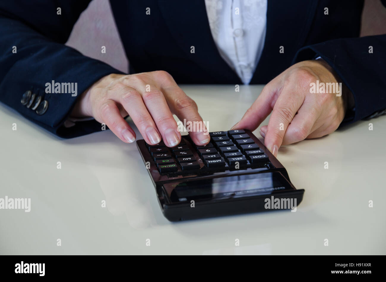 human hand calculating in calculator Stock Photo - Alamy