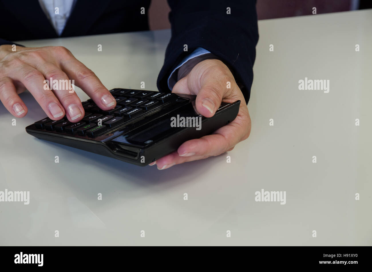 human hand calculating in calculator Stock Photo - Alamy