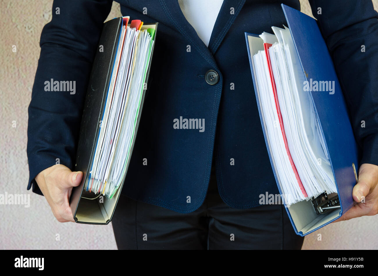 accountant with hands full of folders Stock Photo - Alamy