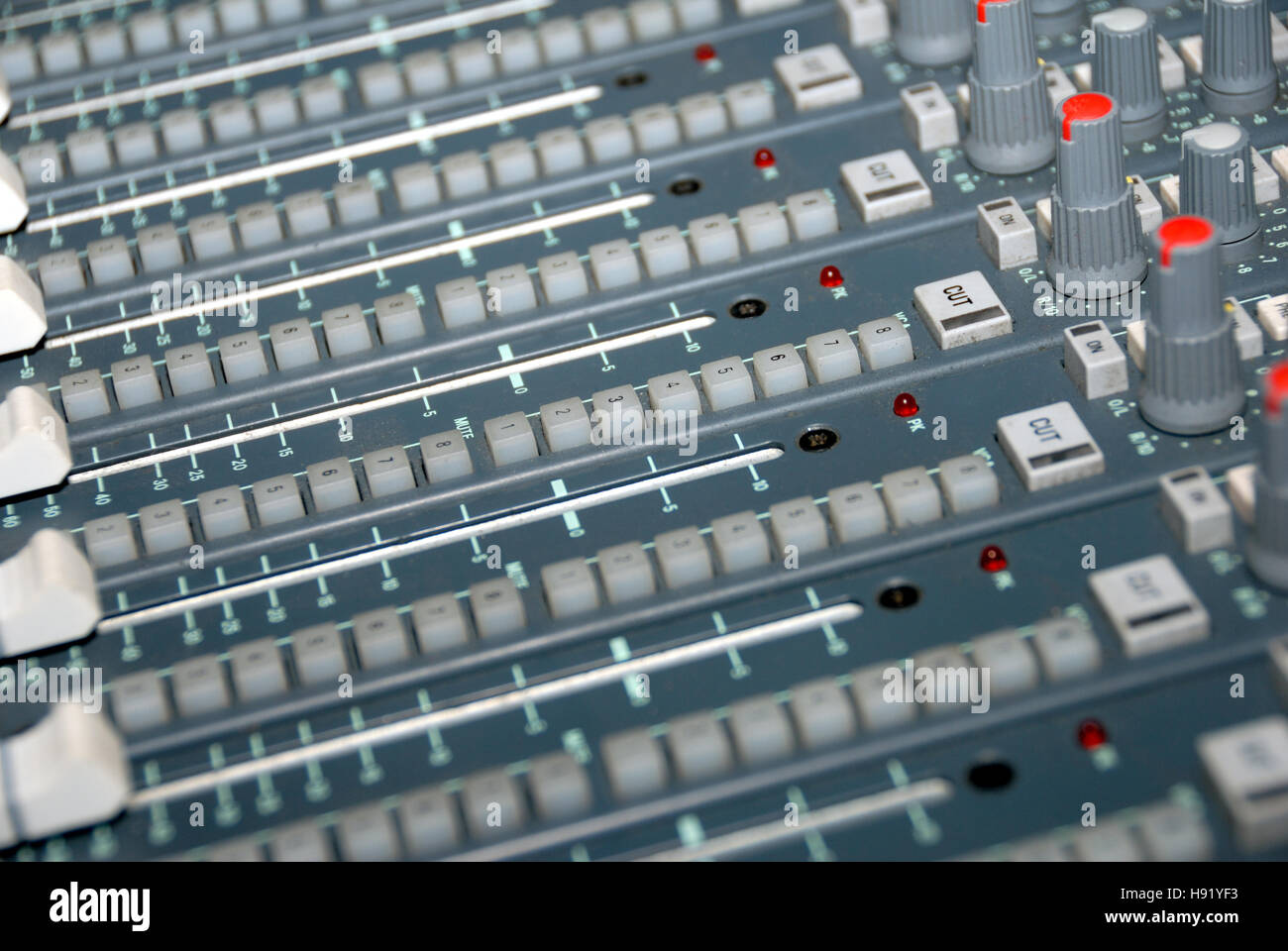 Audio mixing console in a recording studio. Faders and knobs of a sound ...