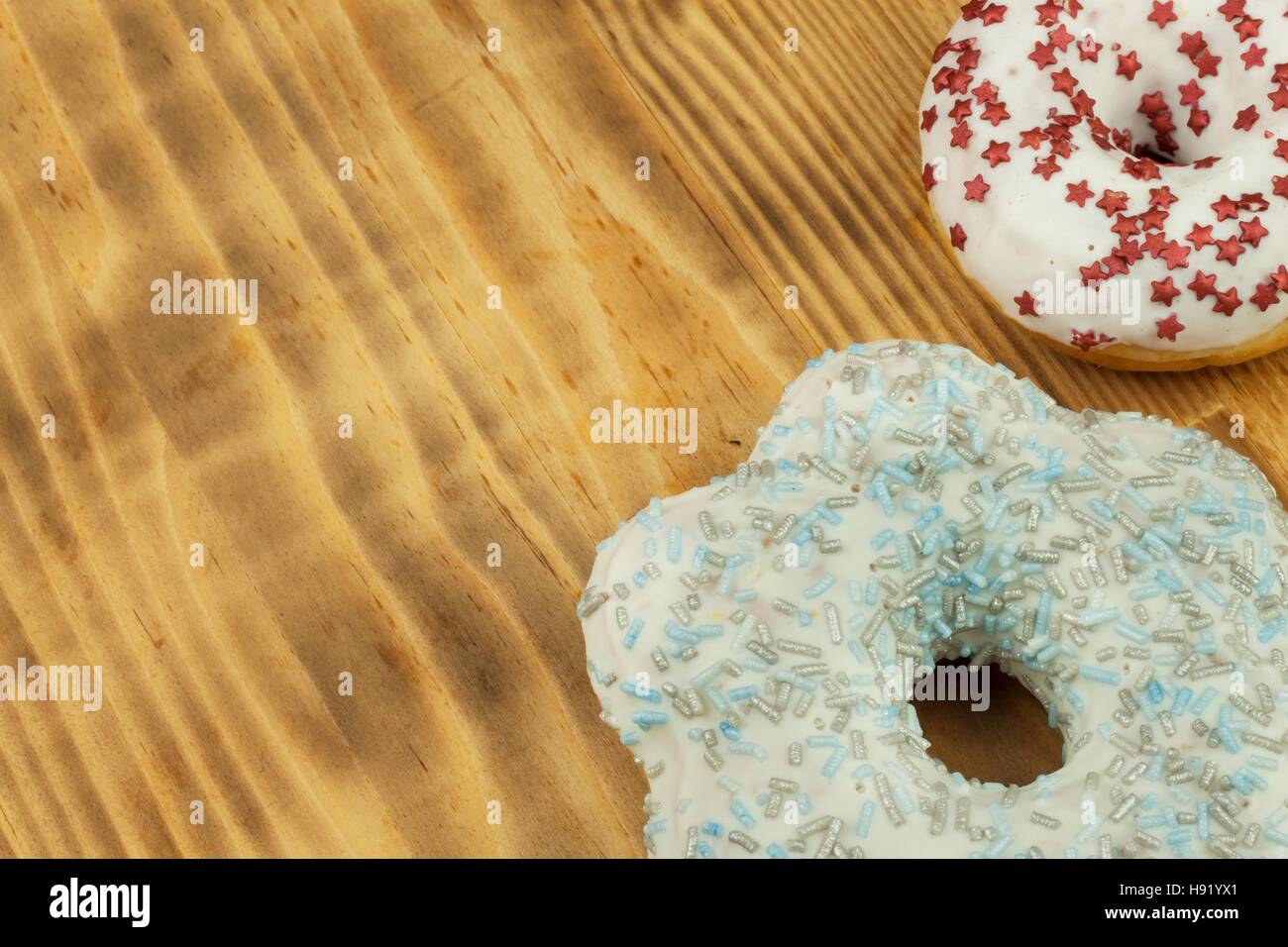 Donuts on wooden background. Sweet donuts with sugar icing. Unhealthy ...