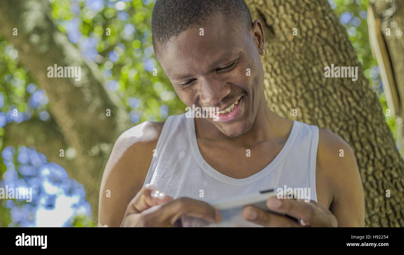 Young African man using smart phone Stock Photo - Alamy