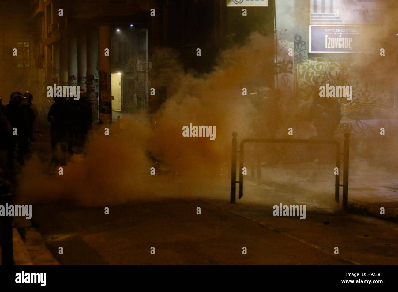 Athens, Greece. 17th Nov, 2016. A smoke bomb burns behind the line of ...