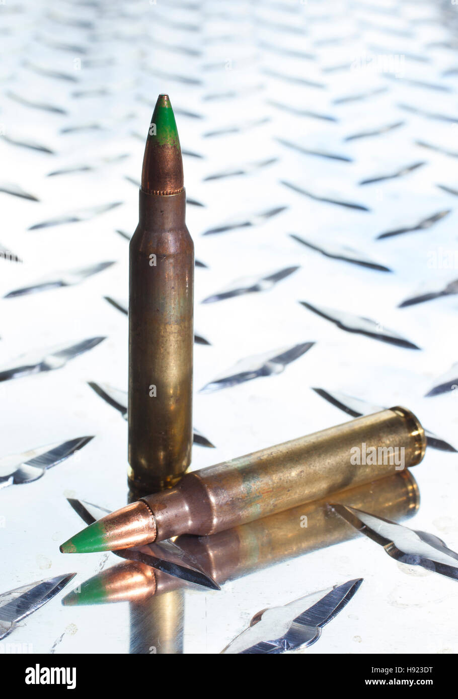 Rifle cartridges with bullets that have steel tips on a chrome plate ...