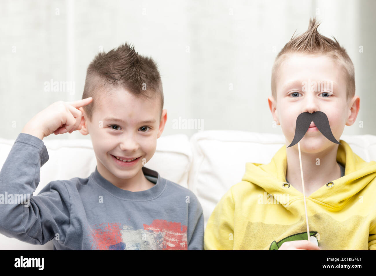 couple of little brothers making funny faces with fake moustaches Stock ...