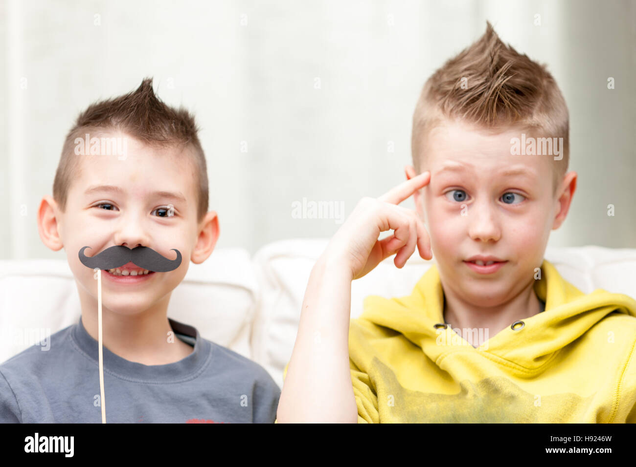 couple of little brothers making funny faces with fake moustaches Stock ...