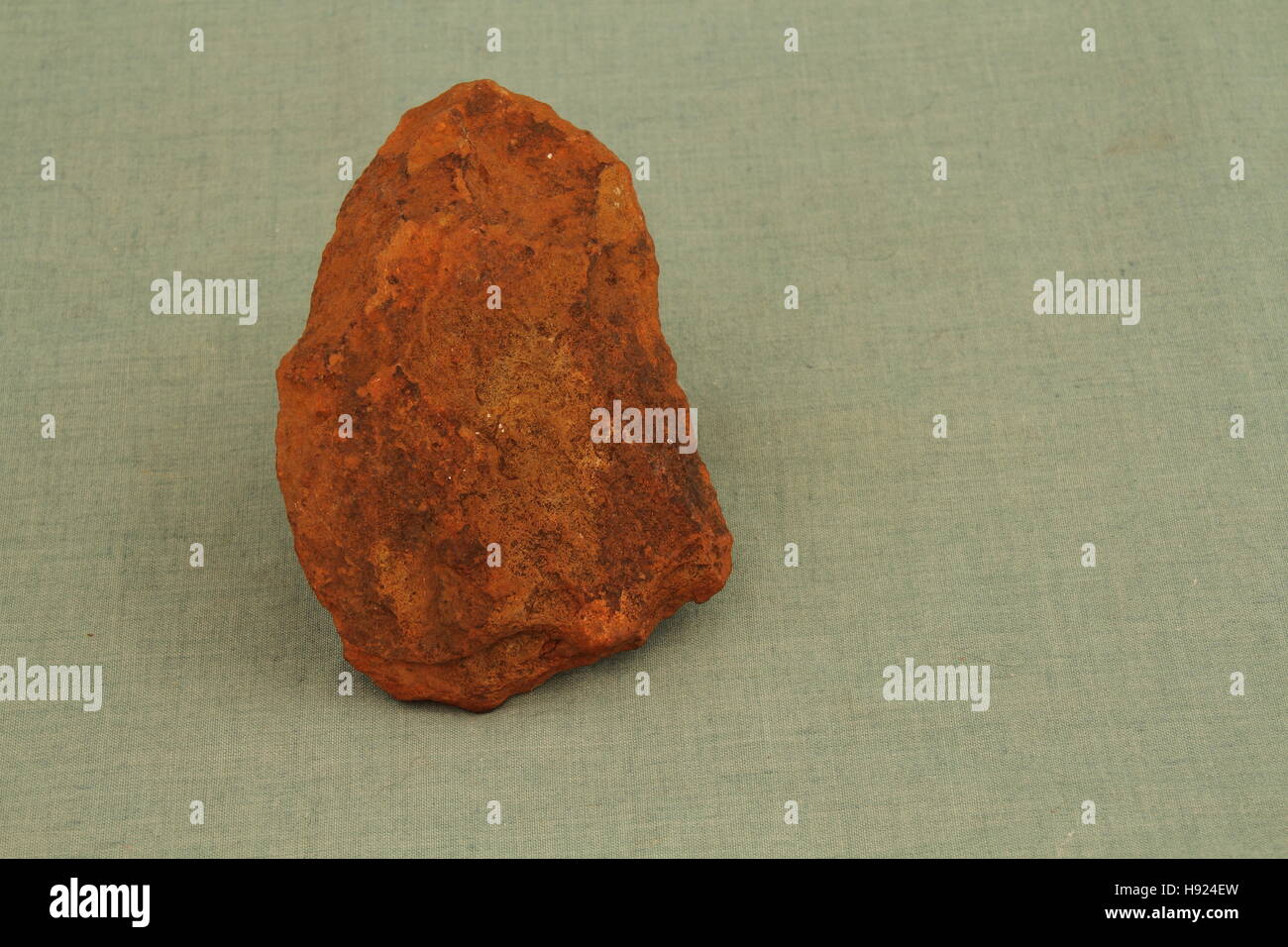 Primitive stone tool isolated on a clear green background image with ...