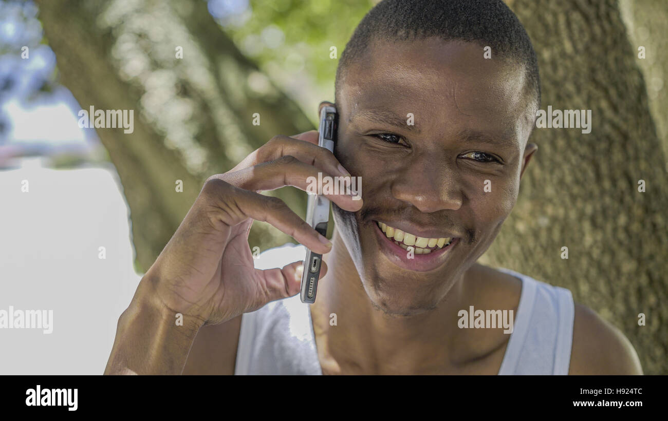 Young African man using smart phone Stock Photo - Alamy