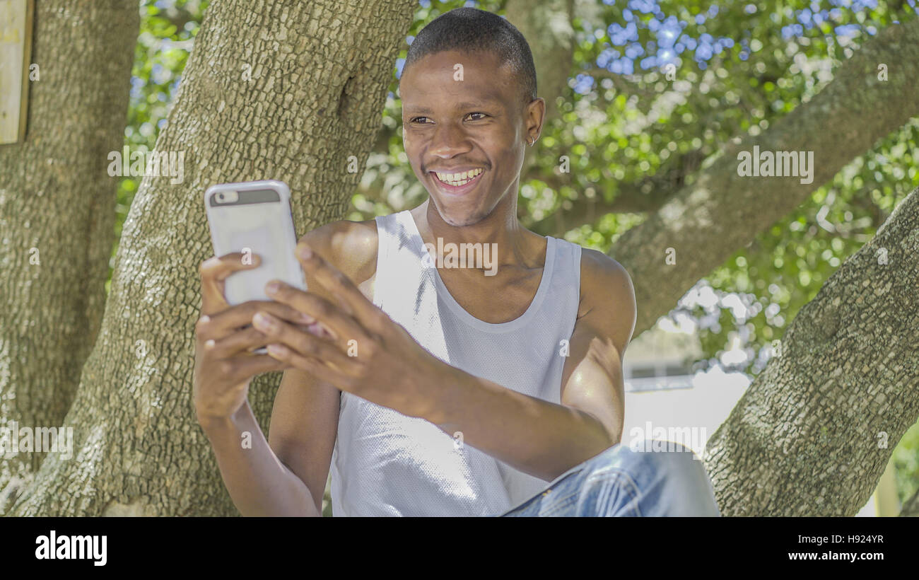 Young African man using smart phone Stock Photo - Alamy