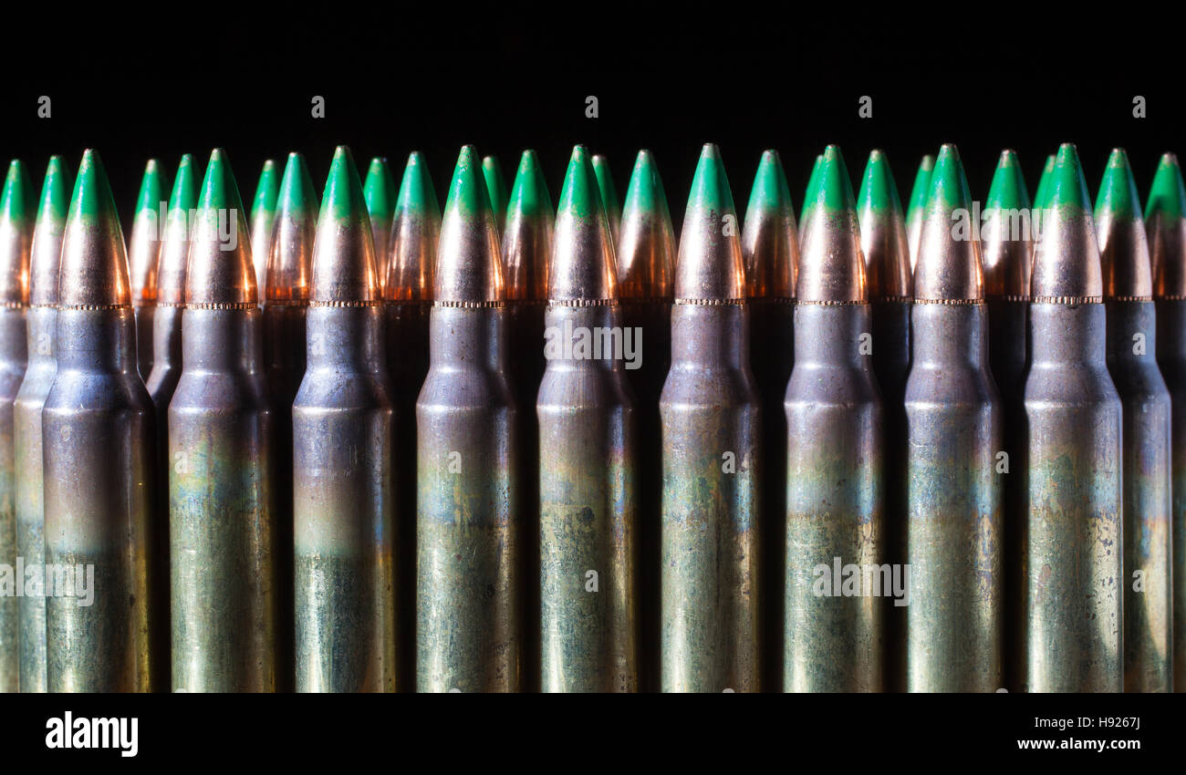 Cartridges that are loaded with bullets tipped in green paint Stock ...