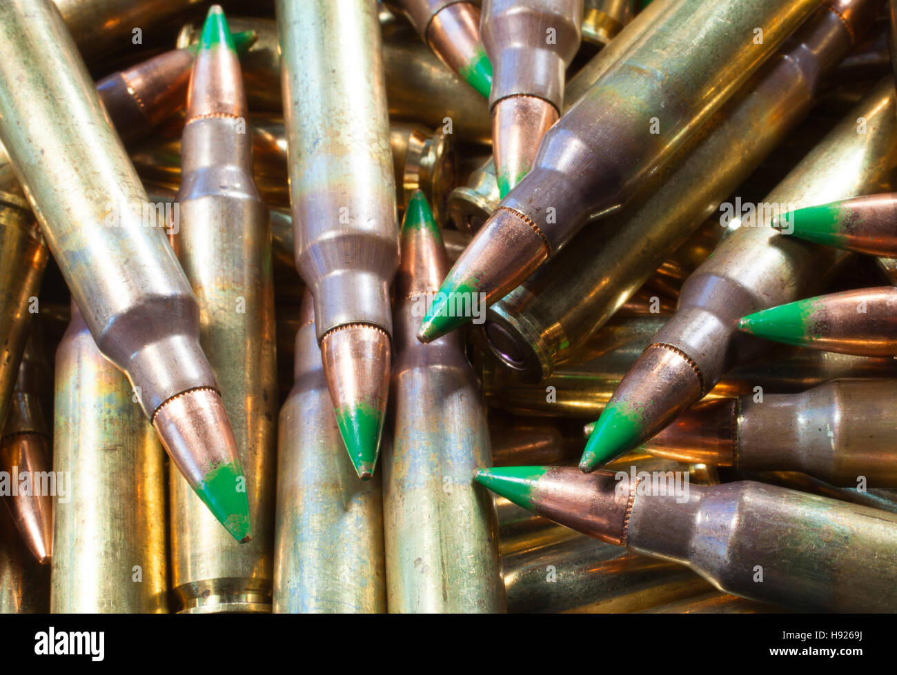 Ammunition with bullets with a green tip in a big pile Stock Photo - Alamy